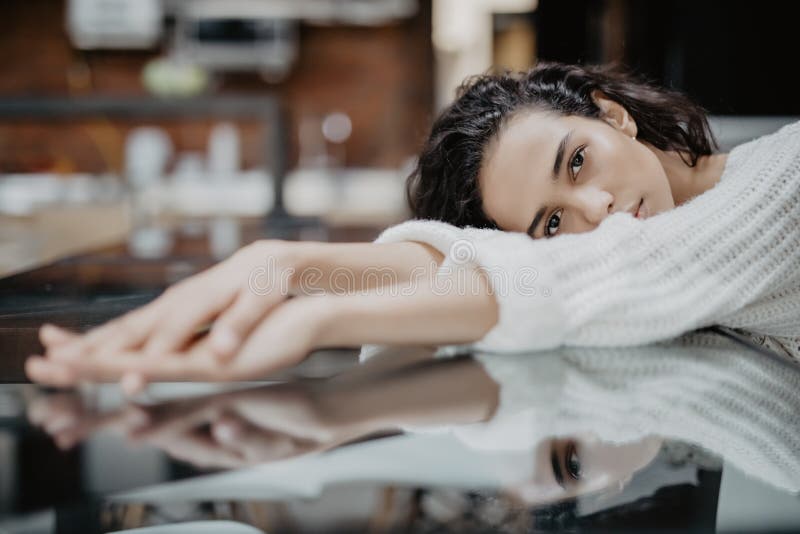 Portrait of a Beautiful Woman Lying on Table at Home Stock Photo ...