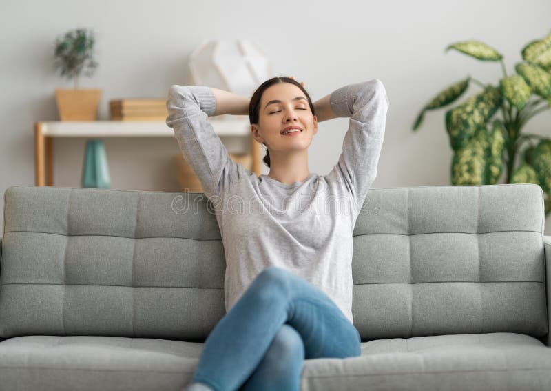 Woman Resting on Sofa at Home Stock Photo - Image of confident, living ...