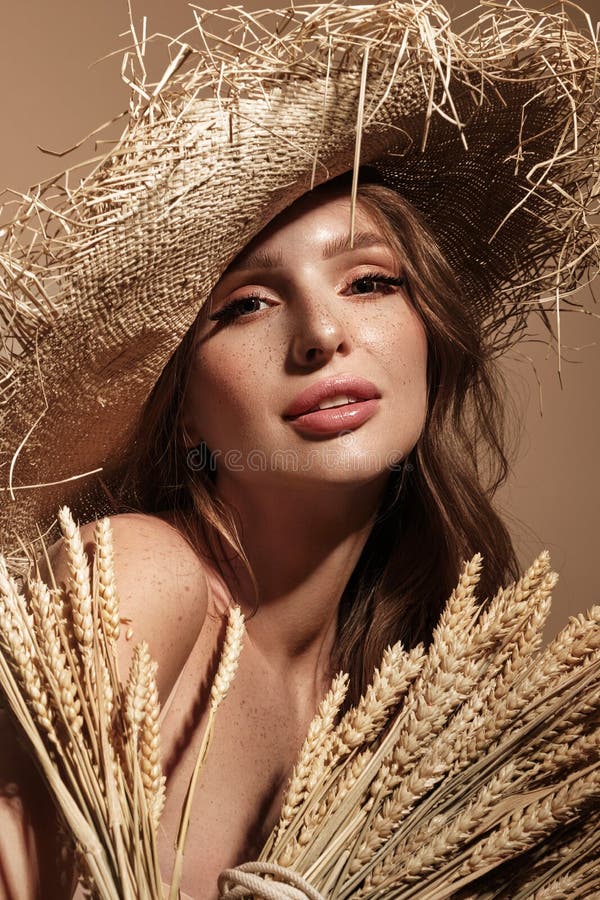 Portrait Of A Beautiful Woman In A Straw Hat Loose Hair And Nude
