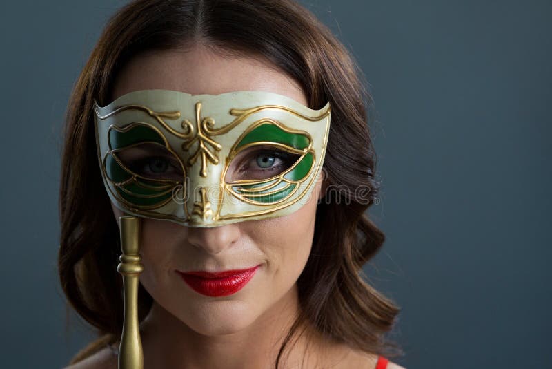 Woman Wearing Masquerade Mask Against Black Background Stock Photo ... Woman Wearing Masquerade Mask Against Black Background Stock Photo ...