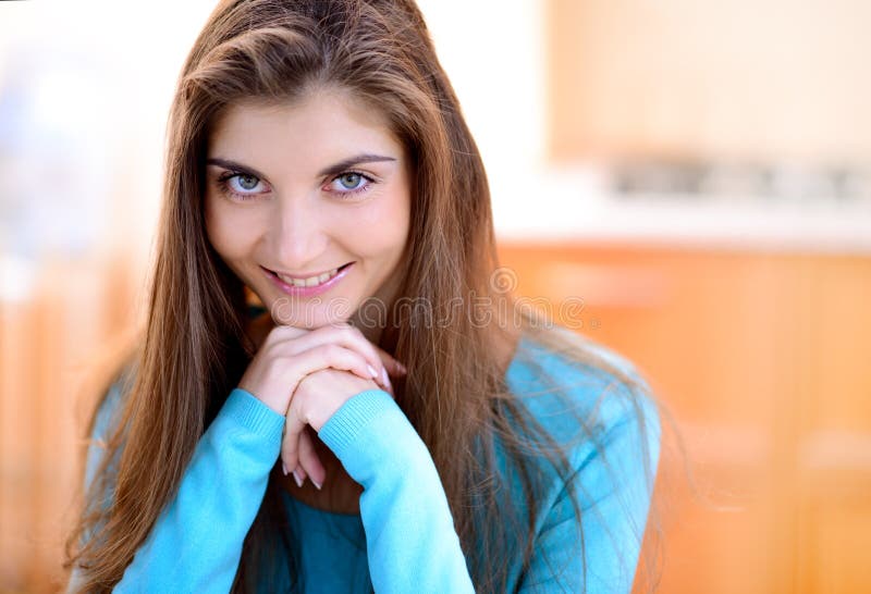 Portrait of a Beautiful Young Lady in the Kitchen at Home and Smiling ...