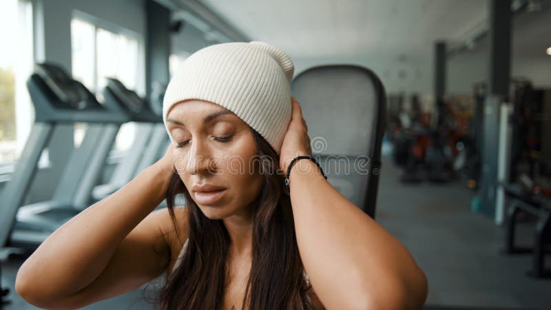 Portrait Of Beautiful Young Tired And Sweaty Woman In White Hat Possing