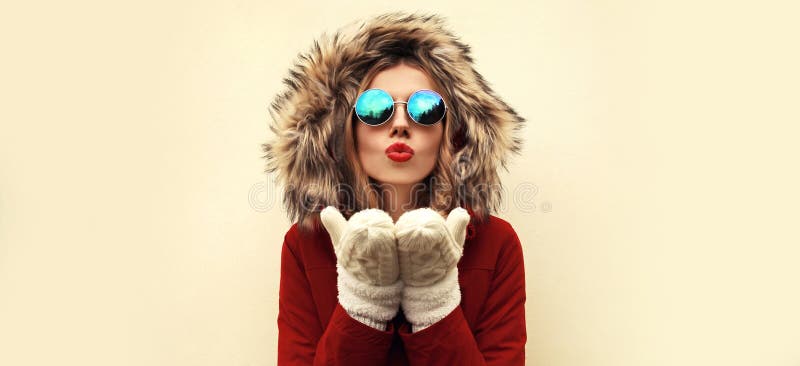 Portrait Of Beautiful Young Woman Blowing Her Lips With Red Lipstick