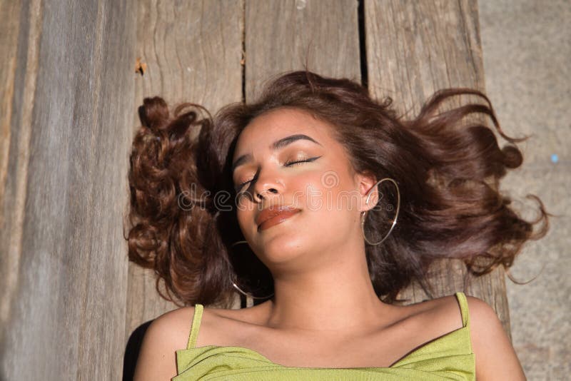 Beautiful Young Woman With Long Brown Hair And Cinnamon Skin Wearing A