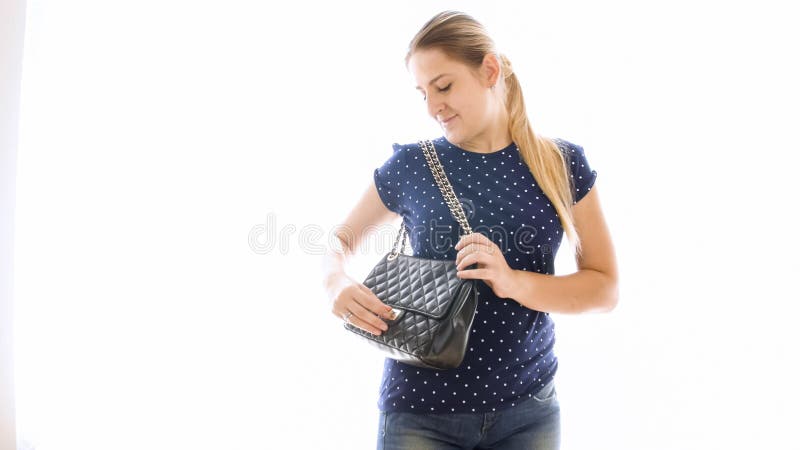 Portrait of Beautiful Young Woman Opens Small Leather Pouch Stock Photo ...