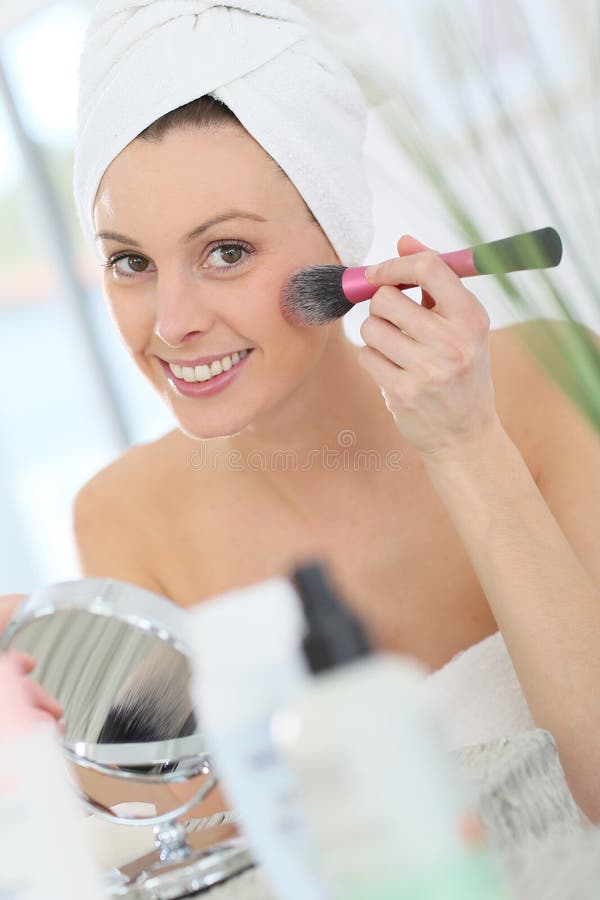 Portrait of a Beautiful Young Woman Putting Makeup on Stock Image ...