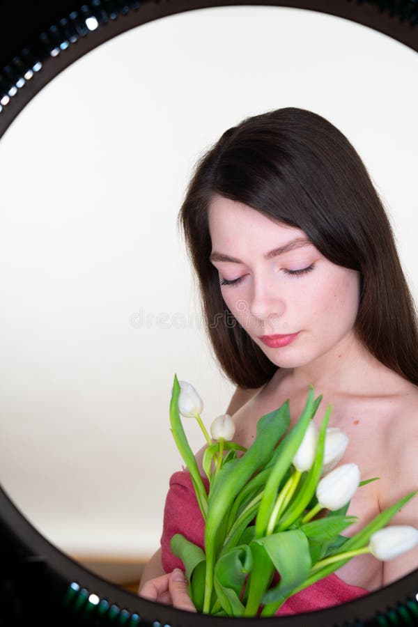 Portrait of a Beautiful Young Woman with White Tulips Made Using a Ring ...