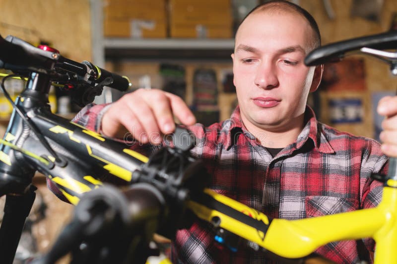 Portrait of a Bicycle Master in a Workshop Installing a Mountain Bike ...