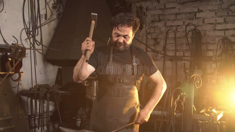 Portrait of a Blacksmith in the Working Atmosphere. a Man Works with ...