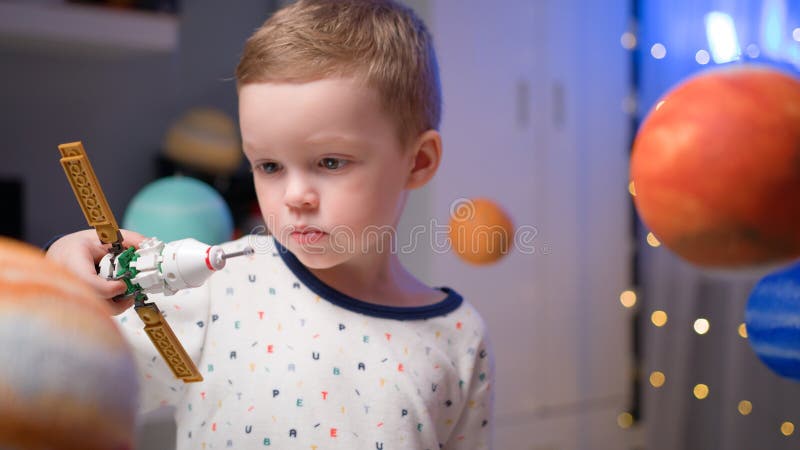 Portrait Blond Boy is Playing with Space Satellite Made by Constructor ...