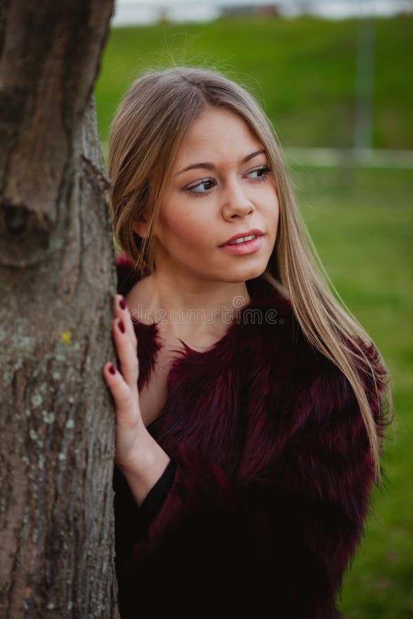 Portrait Blonde Girl Next To a Tree Trunk Stock Image - Image of park ...