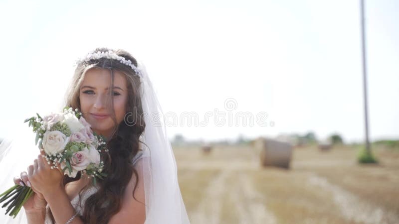 Portrait Of Bohemian Girl Posing Over Wheat Field With Straw Bales Slow Motion Stock Video
