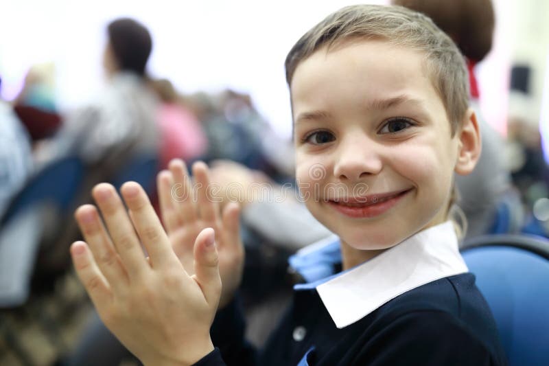 Boy applauds at concert stock image. Image of indoor - 132858027
