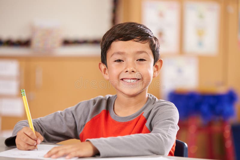 Portrait of a Boy at Elementary School Sitting in Classroom Stock Photo ...