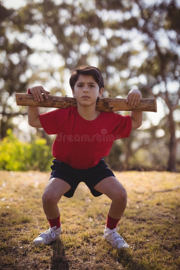 Portrait Boy Exercising with Log during Obstacle Course Stock Photo ...