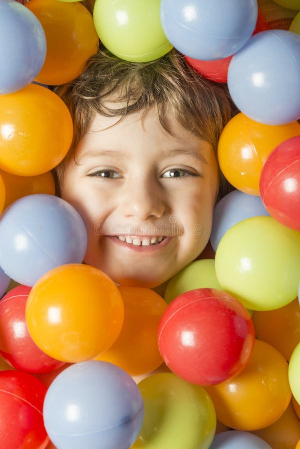 Portrait of a Boy with His Face Surrounded by Colored Balls Stock Photo ...