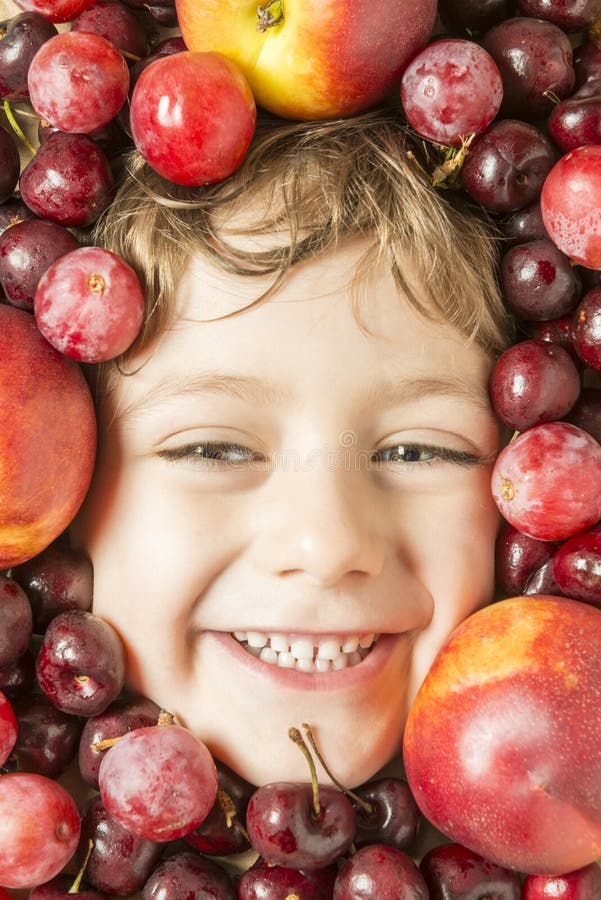 Portrait of a Boy with His Face Surrounded by Fruits Stock Photo ...