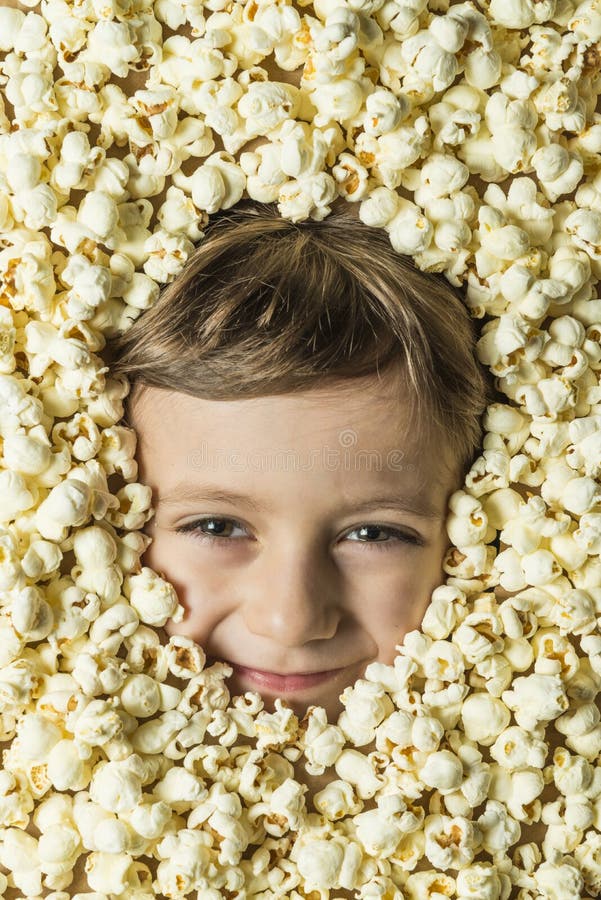 Portrait of a Boy with His Face Surrounded by Popcorn Stock Image ...
