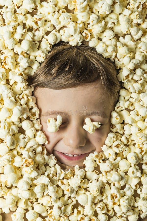 Portrait of a Boy with His Face Surrounded by Popcorn Stock Image ...