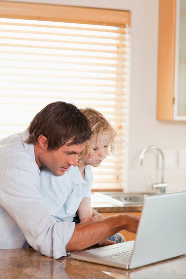 Father and Baby in Dining Room with Laptop Stock Photo - Image of ...