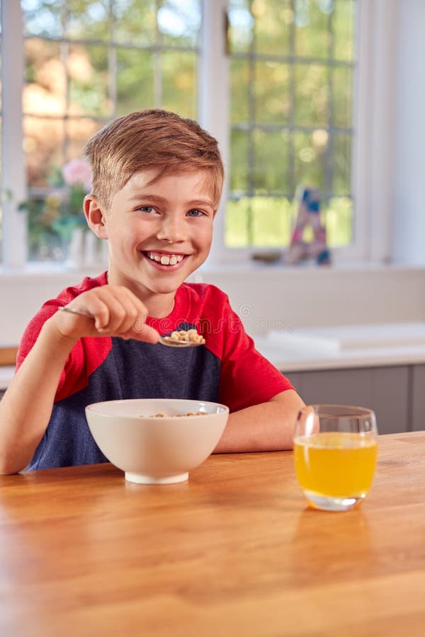 Portrait of Boy at Home Eating Bowl of Breakfast Cereal at Kitchen ...