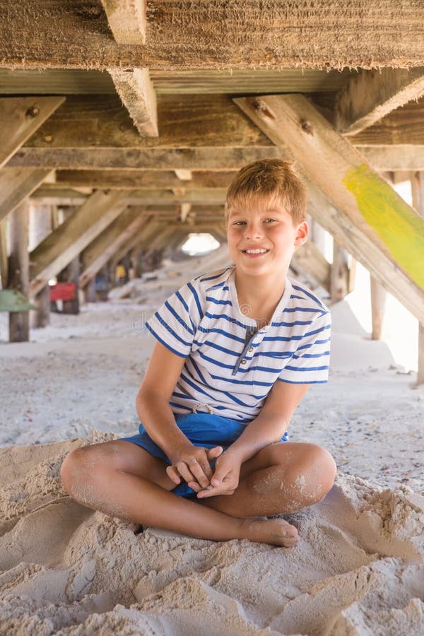 Portrait of Boy Playing with Sand while Sitting Under Hut Stock Photo ...