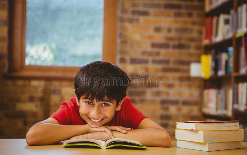 Portrait of Boy Reading Book in Library Stock Photo - Image of ...
