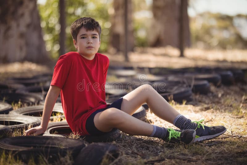 Sad Boy Relaxing on Tyre during Obstacle Course Stock Image - Image of ...