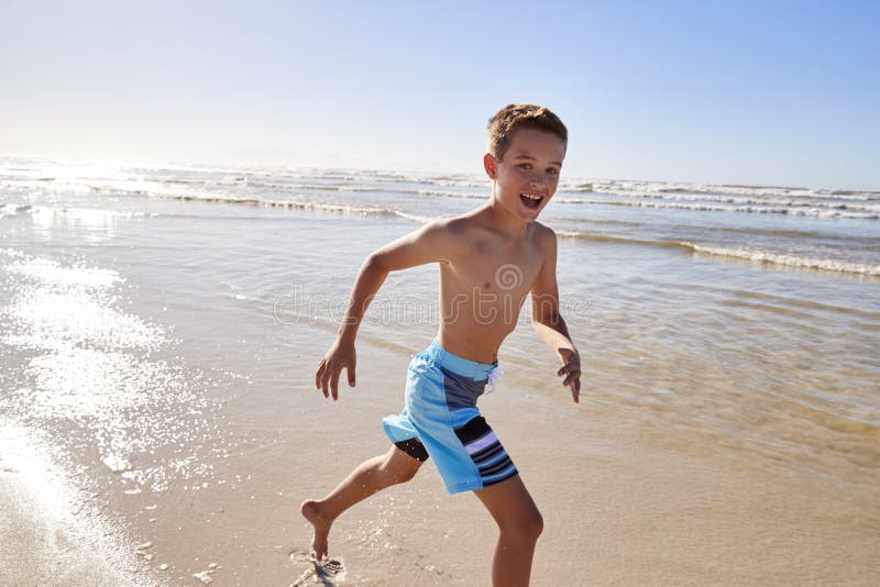 Portrait of Boy Running through Waves on Summer Vacation Stock Photo ...