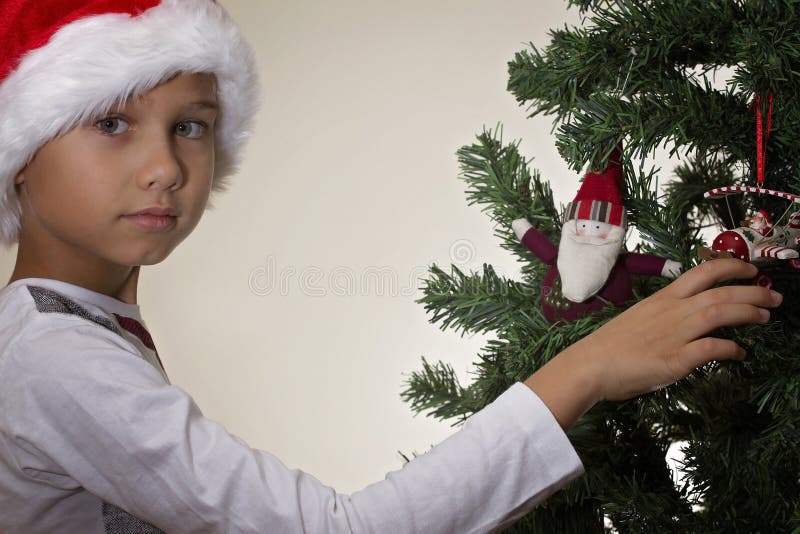 Portrait of Boy in Santa Cap Decorating Christmas Tree Stock Image ...