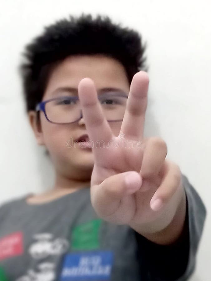 A Portrait of a Boy Showing Number Two with His Hands Stock Photo ...