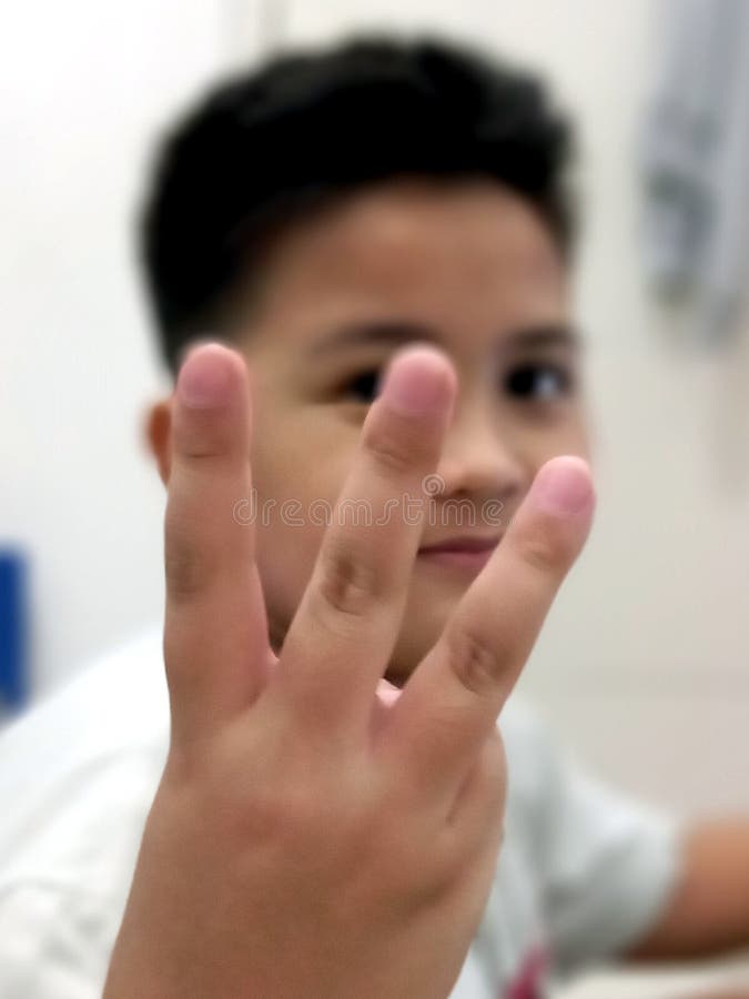 A Portrait of a Boy Shows the Number Three with His Finger Stock Photo ...