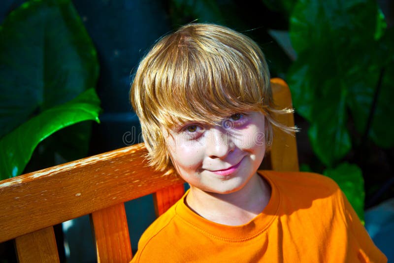 Portrait of a Boy Sitting on a Bench Stock Photo - Image of outdoors ...