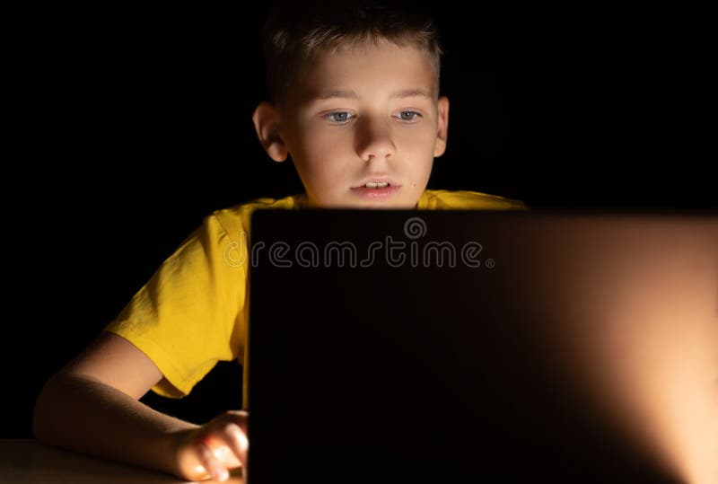 Portrait of a Boy Sitting in the Dark in Front of a Computer Screen ...