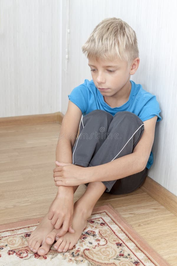 Portrait of Boy Sitting on Floor Looking Away Calm Upset Deep in ...