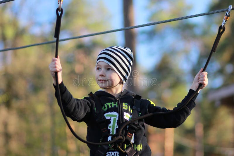 Boy Surmounting Obstacle Course in the Outdoor Rope Park Stock Image ...