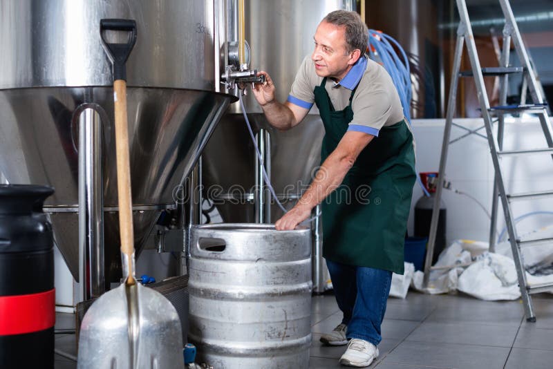 Portrait of Brewer Who is Making Beer and Controls the Process in the ...