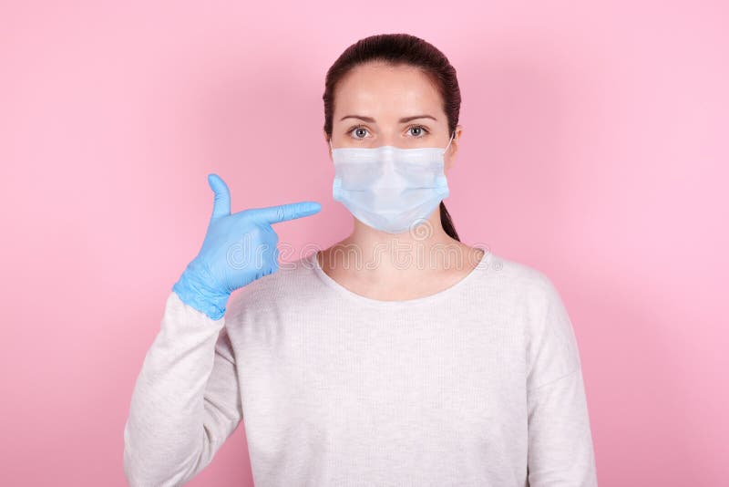 Portrait Of A Brunette Girl In A Medical Mask And Blue Rubber Gloves