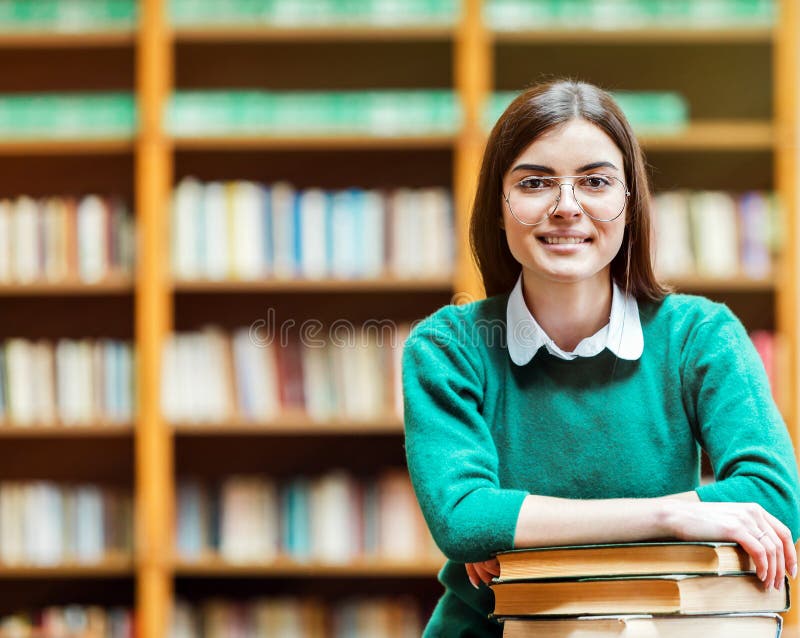 Girl with the Books Stack stock photo. Image of library - 112841076