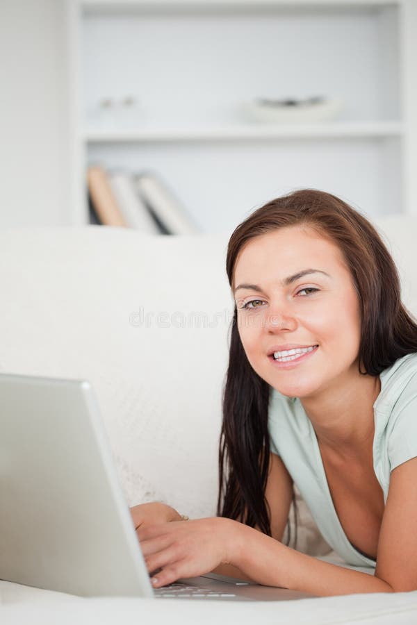 Portrait of a Brunette on a Sofa Using a Laptop Stock Image - Image of ...