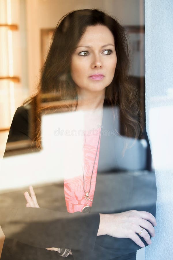 Portrait of Brunette Woman Looking through Window Stock Photo - Image ...