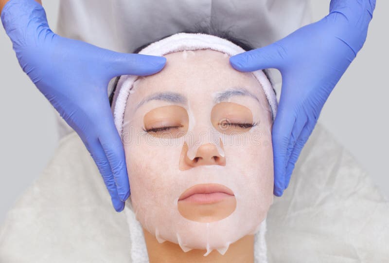 Portrait Of A Brunette Woman Who Makes A Cleansing Mask On Her Face