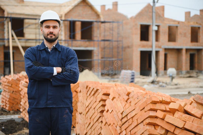 Portrait of a Builder on a Construction Site. Construction of Brick ...