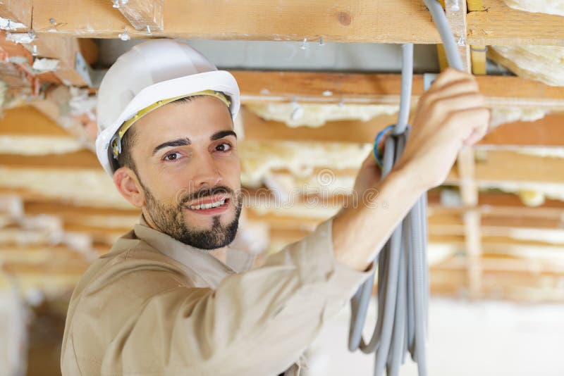 Portrait Builder Installing Cable into Roof Space Stock Image - Image ...