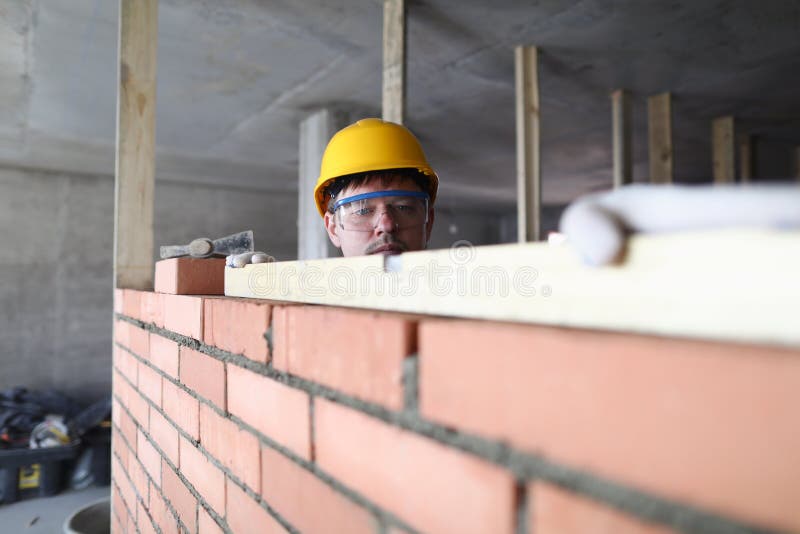 Portrait of Builder Laying Bricks Using Special Tools. Worker Building ...