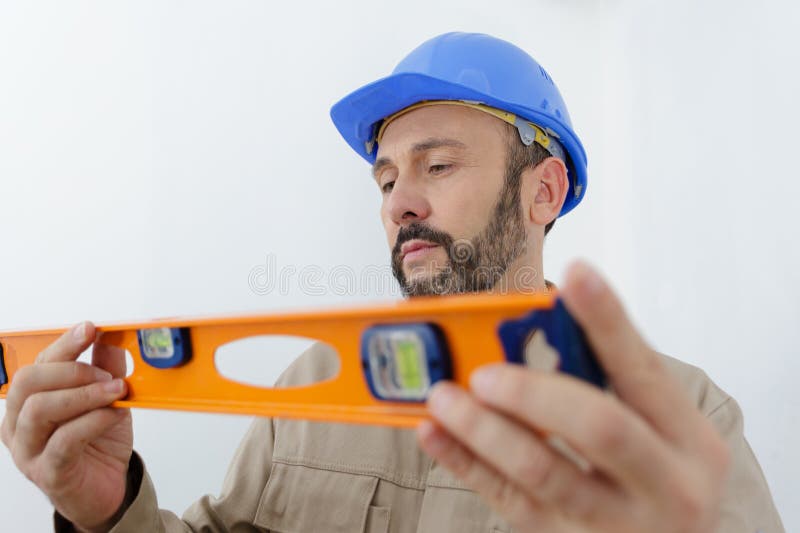 Portrait Builder Man in Uniform Standing with Spirit Level Stock Photo ...
