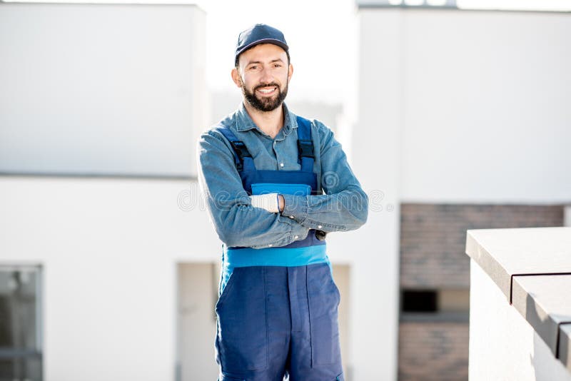Portrait of a Builder in Uniform on the Roof Stock Image - Image of ...