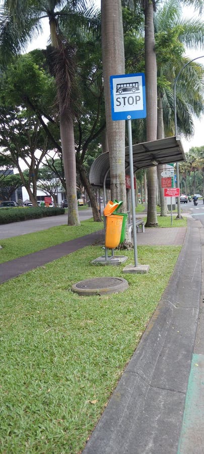 Portrait of a Bus Stop and Some Trash Cans in a City Park Stock Image ...