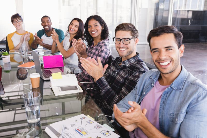 Portrait of Business Team Clapping while Sitting at Creative Office ...
