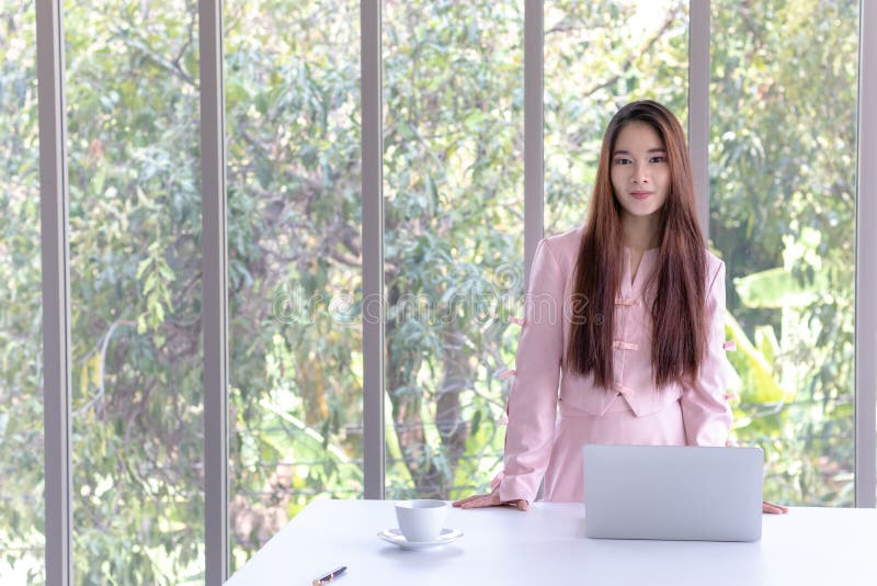Portrait Of A Business Woman An Asian Woman In A Pink Dress Is A